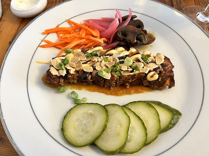 Roasted pork belly glistens with caramelization, surrounded by colorful accompaniments that balance its richness with bright, acidic counterpoints.