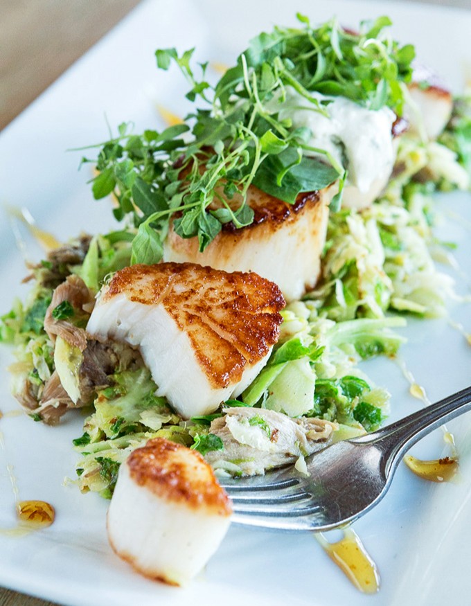 Perfectly seared scallops perched atop a vibrant salad&mdash;like tasty little hockey pucks of the sea that scored the culinary hat trick.