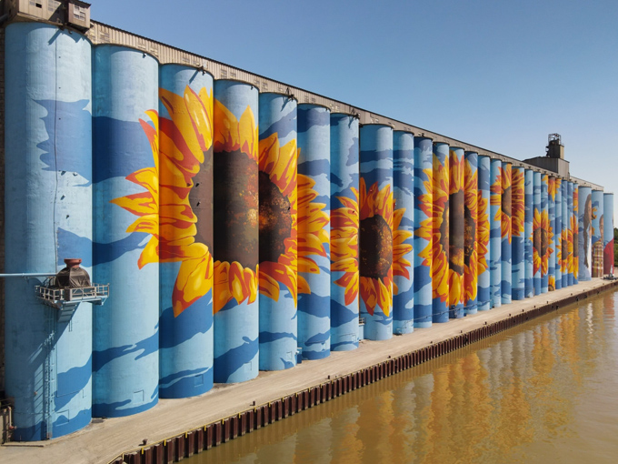 The curved surfaces of these silos created unique challenges for artists, requiring special techniques to ensure proper proportions from all viewing angles.