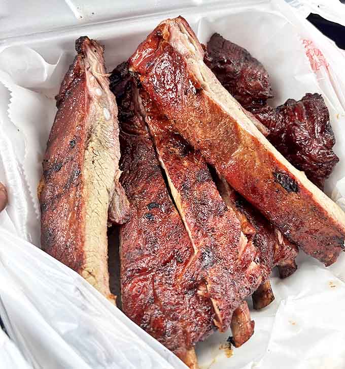 Those smoked pork spare ribs have that perfect bark and fall-off-the-bone tenderness that makes vegetarians question their life choices.