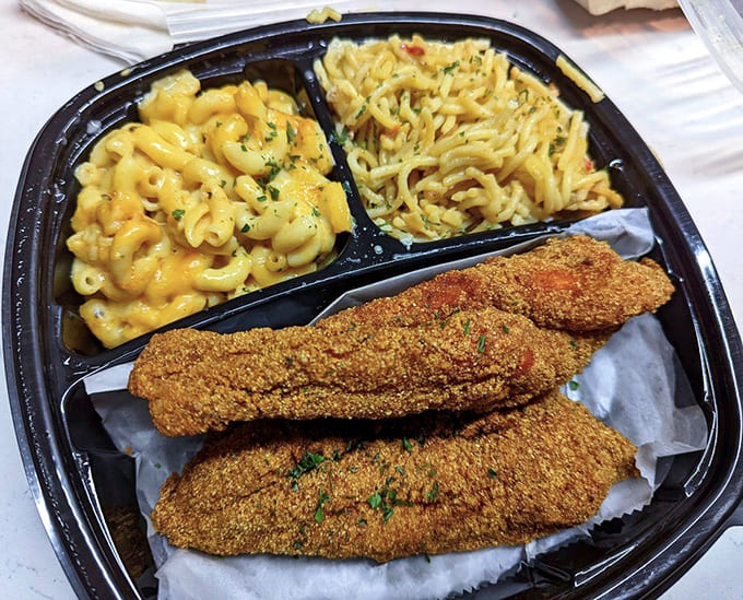 Two pieces of perfectly fried catfish flanked by sides that could easily steal the show on their own.