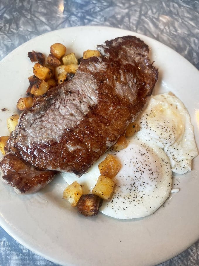 The steak and eggs plate means business &ndash; a properly seasoned cut alongside sunny-side-up eggs and those addictive home fries. Breakfast of champions!