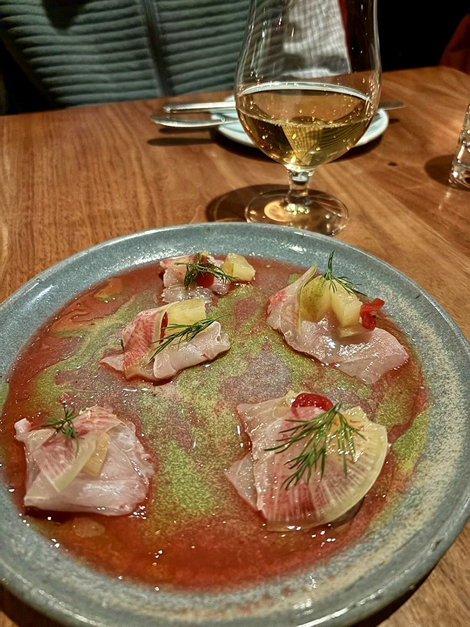 Striped bass crudo with delicate herbs and citrus – like the ocean took a delightful vacation to a Vermont garden.