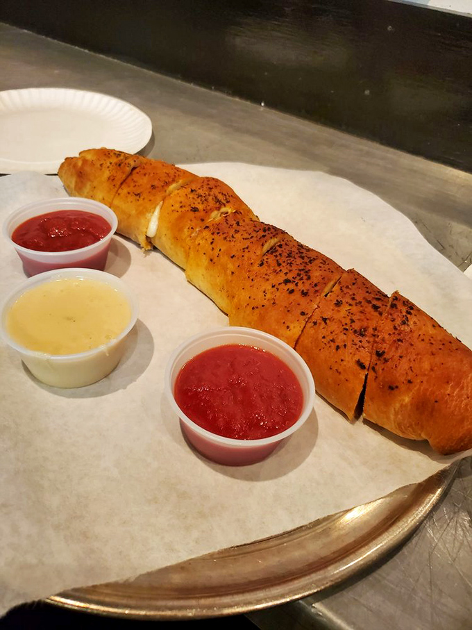 A golden-brown envelope of deliciousness, this stromboli delivers its cheesy, savory contents with dipping sauces standing by for backup.