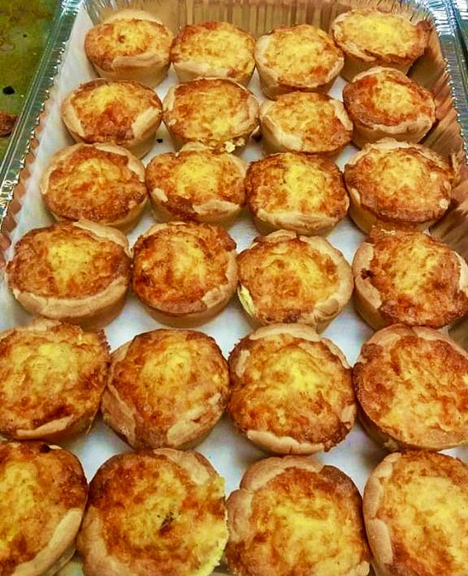 Mini quiches arranged like little savory treasures, perfect for when you need protein but refuse to give up on deliciousness.