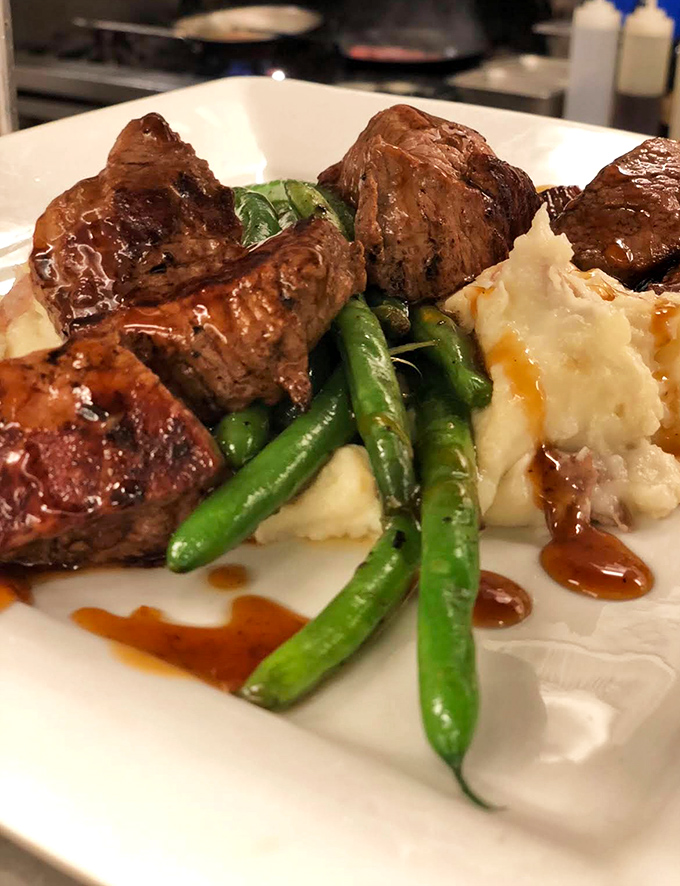 Teriyaki steak tips glisten beside creamy mashed potatoes and vibrant green beans &ndash; comfort food that hugs your soul from the inside.