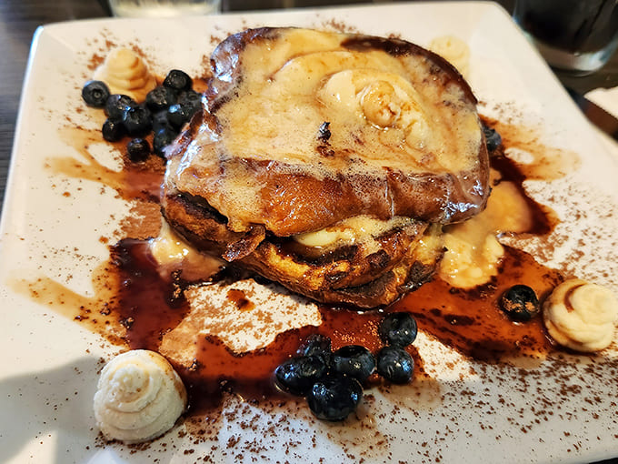 French toast elevated to art form &ndash; caramelized edges, fresh berries, and a dusting of powdered sugar create breakfast that's worth getting out of bed for.