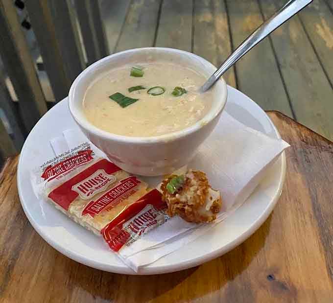 Creamy, comforting soup arrives with crackers and the kind of warmth that makes you forget about whatever's happening outside.