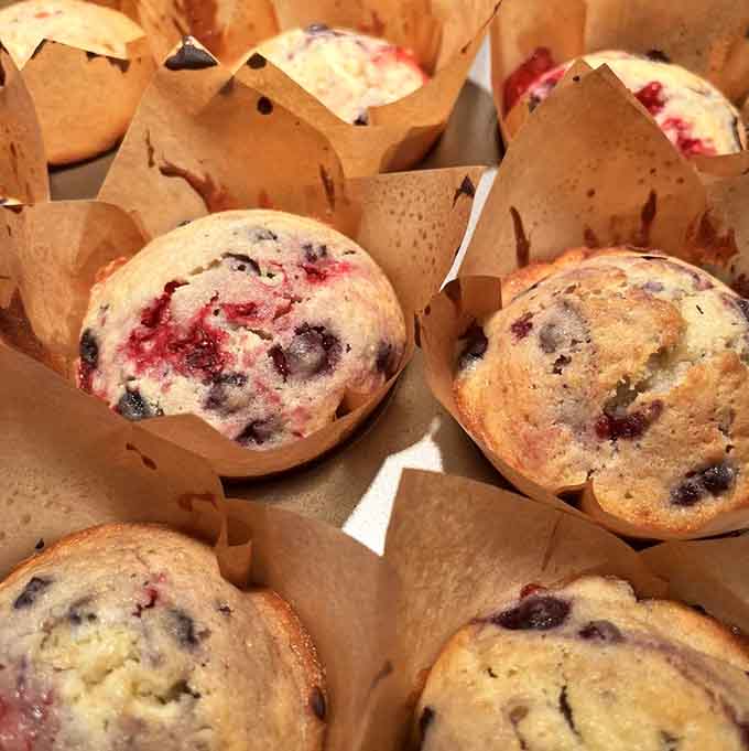 Berry muffins bursting with fruit like they're trying to win a "most generous baker" award, and honestly, they might just deserve it.