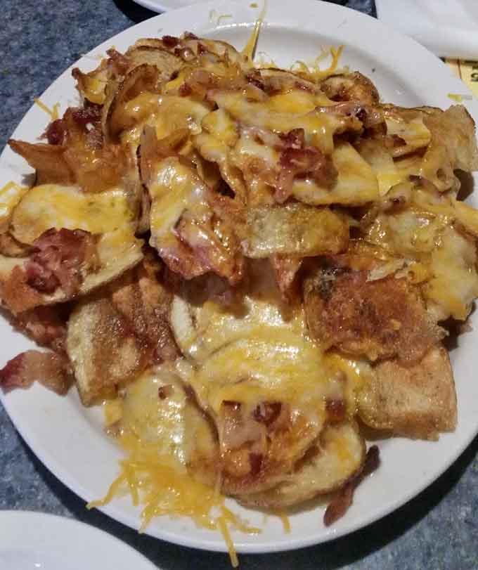 These loaded nachos buried under melted cheese and toppings could easily serve as a meal for two hungry diners.