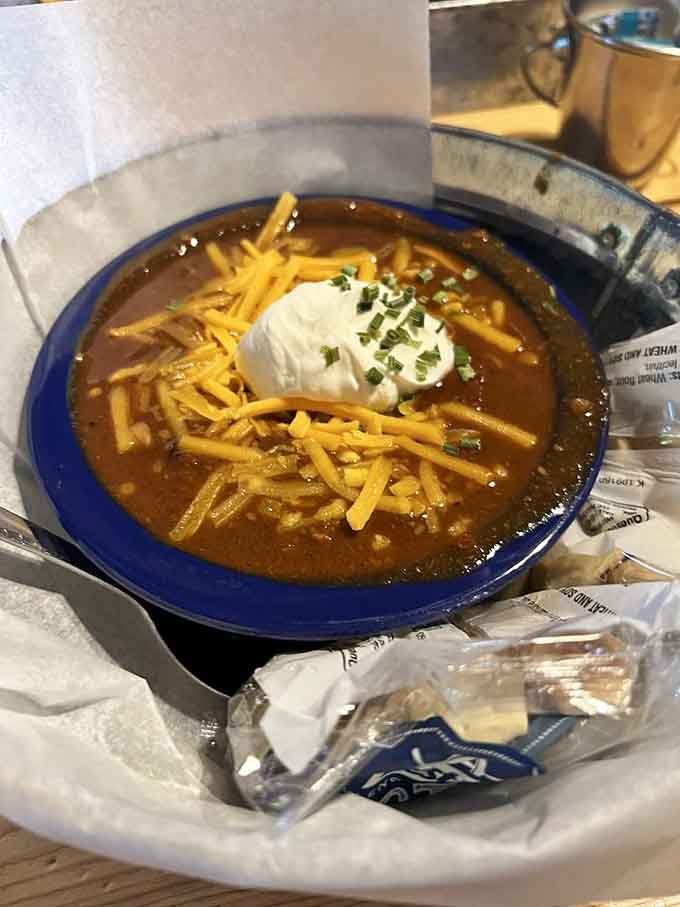 Homemade chili topped with cheese and sour cream, because sometimes you need a bowl of warmth.