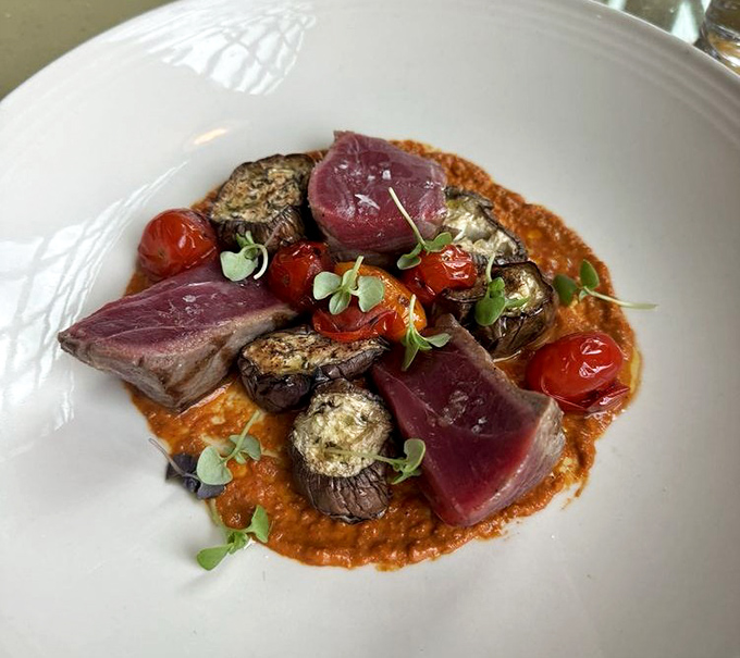 Tuna that flirts with perfection &ndash; ruby-red slices nestled against roasted vegetables and a sauce that deserves its own fan club.