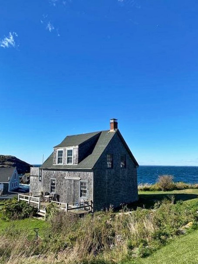 This weathered island cottage has witnessed a century of Atlantic storms, yet stands proudly against the backdrop of Maine's endless horizon.