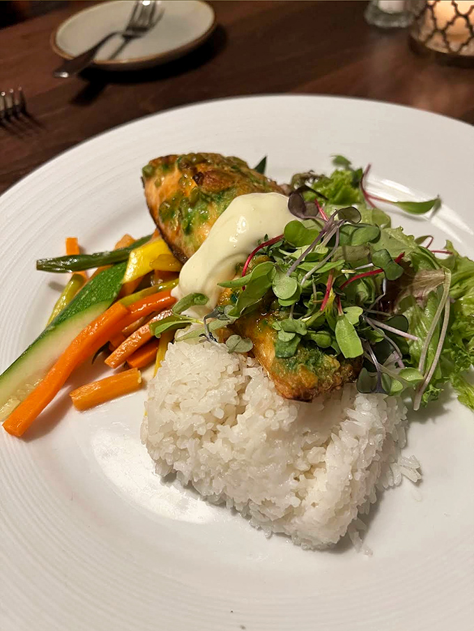A fish dish that's dressed for success &ndash; crispy, colorful, and perched atop rice like it's posing for a food magazine.