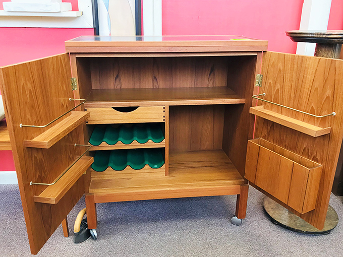 This Danish modern bar cabinet reveals its secrets when opened, its clever design making you wonder why we ever abandoned such functional elegance.