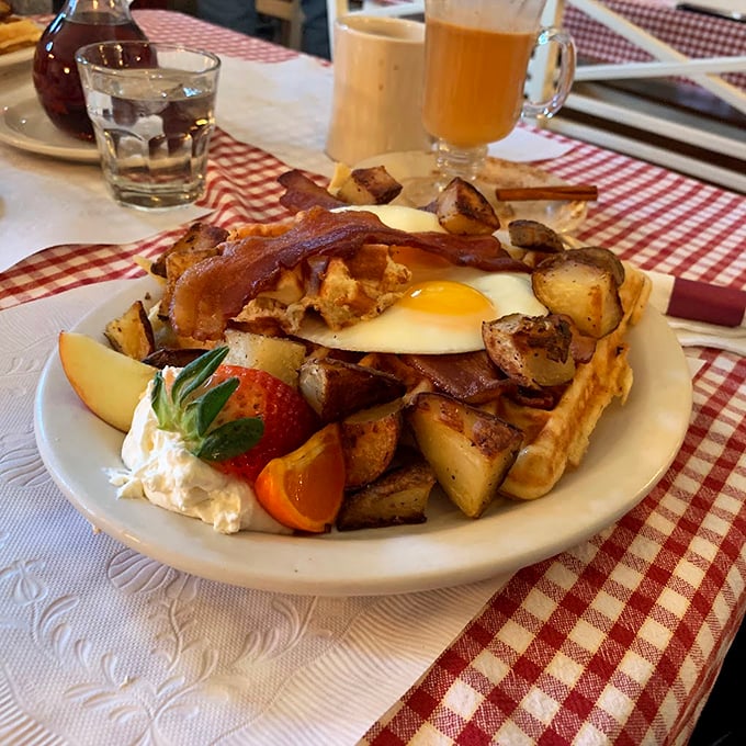 Breakfast doesn't get more Vermont than this &ndash; locally sourced eggs, potatoes, and bacon arranged on a plate like edible artwork, with fresh fruit adding a pop of color.