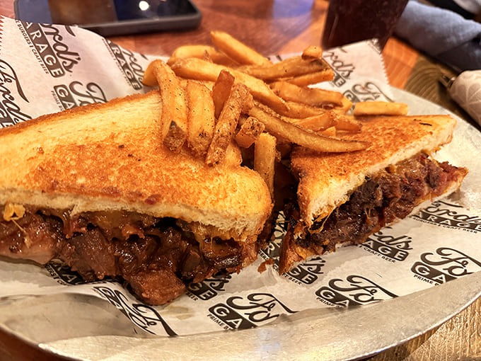 Between two perfectly toasted slices lies a brisket revelation so tender, it practically surrenders to your fork before you even pick it up.