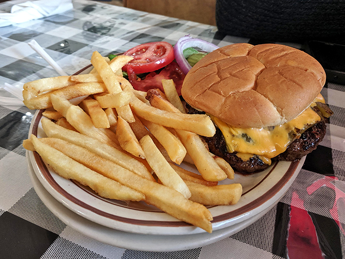 Every component thoughtfully arranged &ndash; the crisp lettuce, ripe tomato, and perfectly melted cheese complement rather than compete with the star: that juicy patty.
