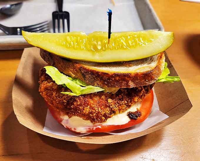 The Nashville Hottie brings southern heat to Michigan's lakeshore, with crispy chicken, sweet-spicy pickles, and house-made spicy coleslaw creating a sandwich worth sweating for.