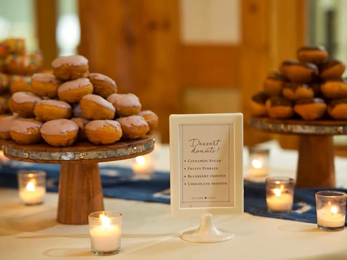 Elegant simplicity: These classic glazed donuts transform any special occasion, arranged on wooden stands with flickering candles for ambiance.