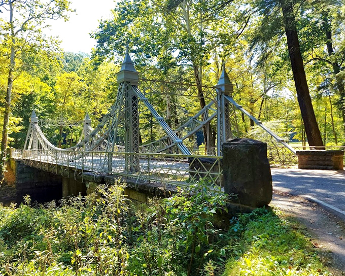 Summer's lush embrace surrounds the white latticework, creating a cool retreat for hikers and photographers alike.