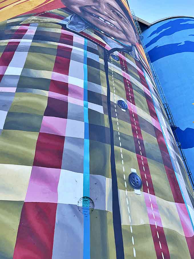 Looking up from the riverbank, the silos transform from industrial relics to towering artistic statements that command the Toledo skyline.