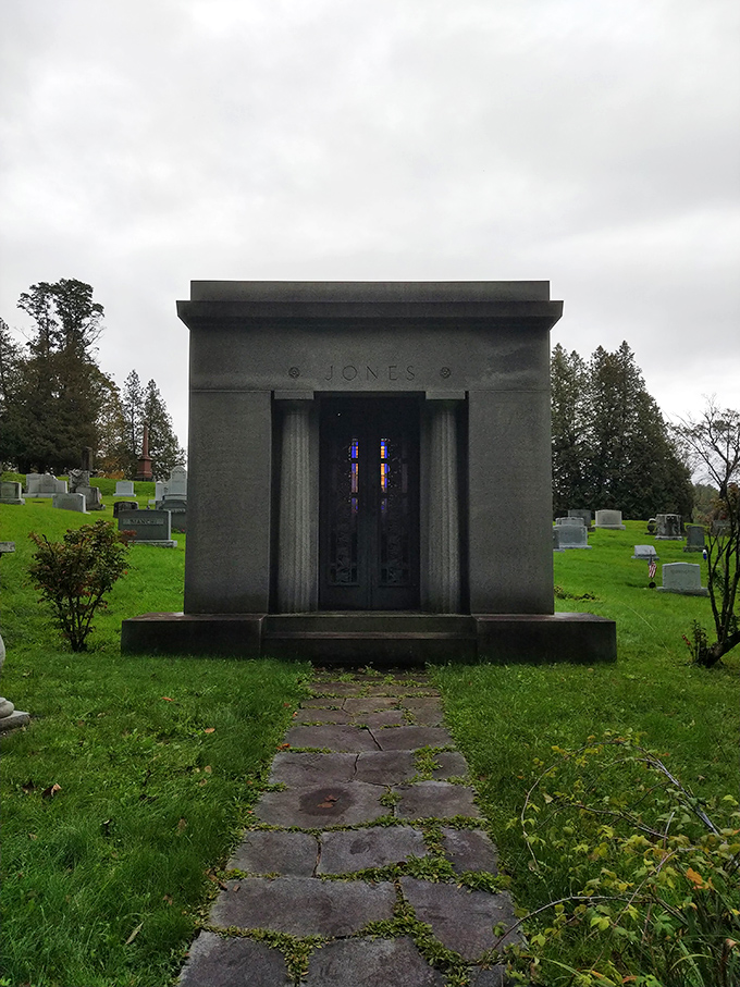 The Jones mausoleum stands like a miniature temple, its stained glass windows filtering colored light onto the cold stone floor within.