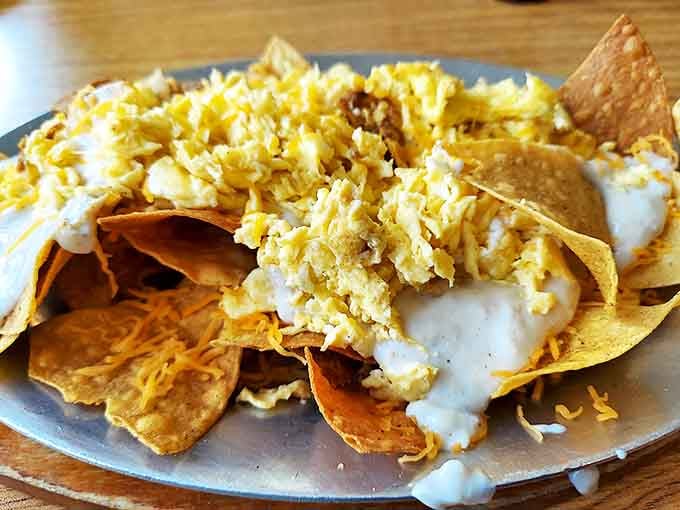 Breakfast nachos that blur the line between morning meal and fiesta – crispy chips loaded with eggs, cheese, and enough toppings to require a strategy.