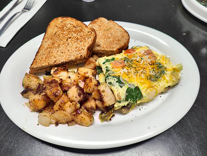 A fluffy omelet that's somehow both substantial and light, paired with home fries that actually taste like potatoes. Imagine that!