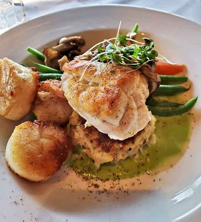 A symphony of textures and flavors &ndash; delicate fish and caramelized scallops sharing the spotlight with seasonal vegetables.