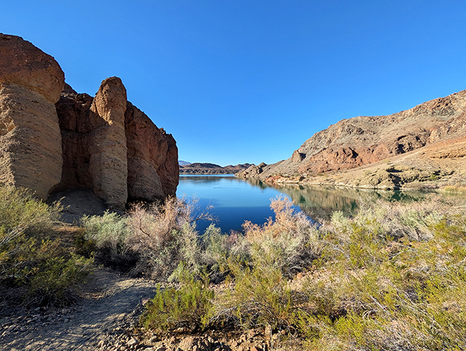 Hidden ponds reflect the harsh beauty of desert terrain, like nature's version of finding an unexpected twenty in your pocket.