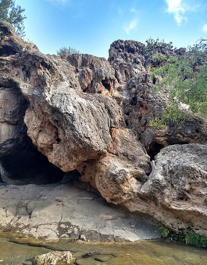 Ancient formations: Millions of years of mineral deposits have created these distinctive rock structures that frame the creek.