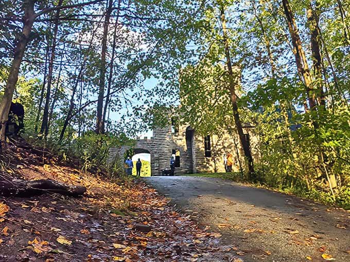 The forest parts to reveal stone towers and turrets, creating that magical moment when hikers first glimpse the castle through the trees.