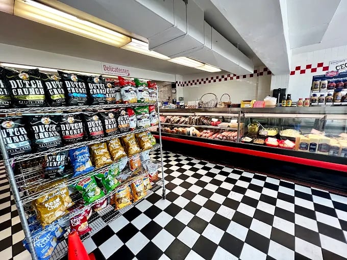 The deli counter &ndash; where sandwich magic happens amid the controlled chaos of paper-wrapping and meat-slicing choreography.