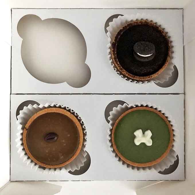 Four perfect reasons to share (or not): A quartet of tarts nestled in their box like edible jewels, each one vying to be eaten first.