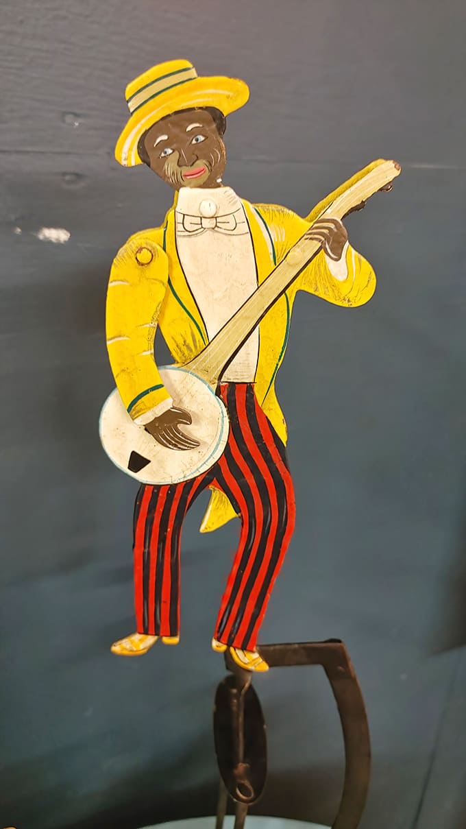 Vintage folk art captures a bygone era &ndash; this colorful banjo player figurine representing the market's collection of nostalgic Americana and cultural artifacts.