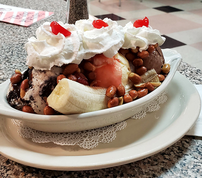 The triple threat &ndash; three distinct ice cream flavors sharing real estate with fresh banana and topped with a cloud of whipped cream.