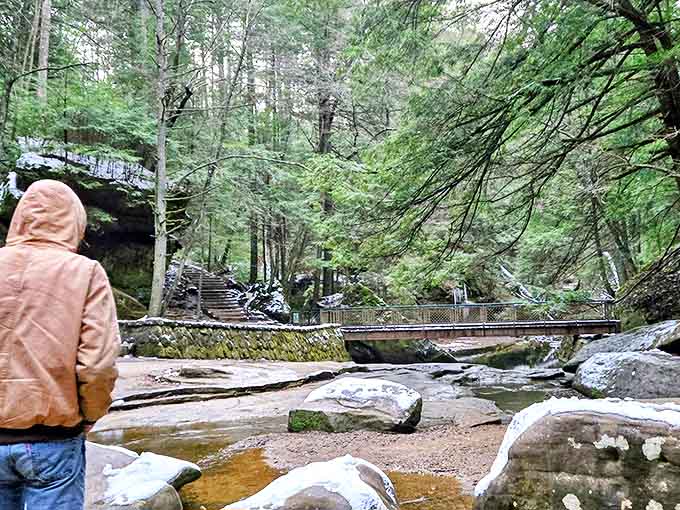 Even in chilly weather, the park's natural beauty draws visitors seeking solitude among the towering hemlocks and sandstone cliffs.