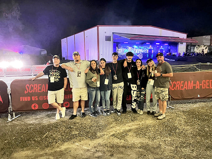 A group of thrill-seekers poses after surviving the gauntlet of horrors &ndash; their smiles hiding the residual terror.