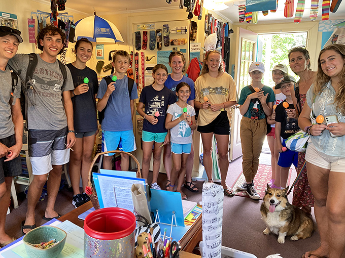 Young museum-goers gather for a group photo, clutching colorful tokens from their visit &ndash; the next generation of umbrella cover appreciators!