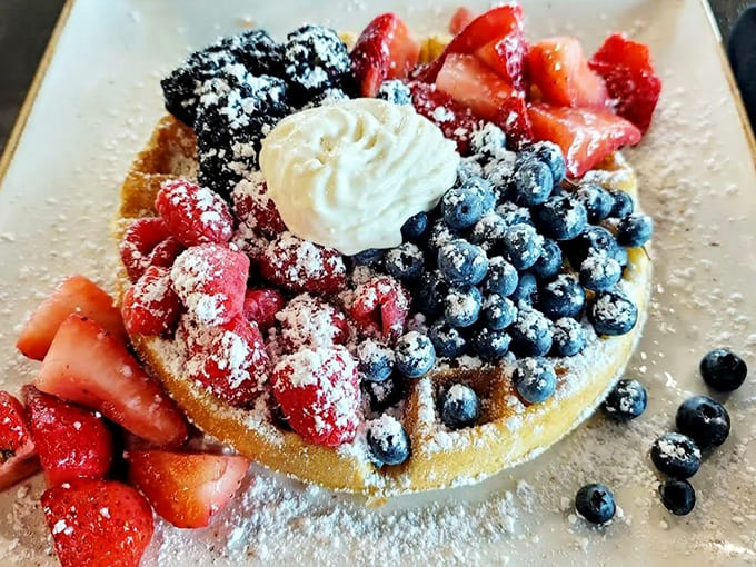 A Belgian waffle that's basically dessert for breakfast &ndash; crisp edges, tender center, and a berry medley that makes you feel virtuous despite the indulgence.