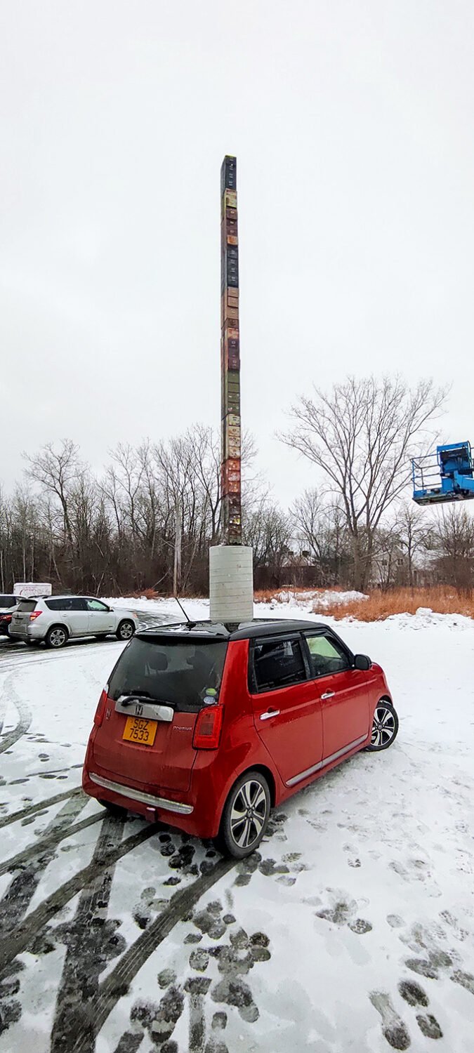 Even in winter's embrace, the filing cabinet stands defiant against the snow, a dark exclamation point on Vermont's white landscape.