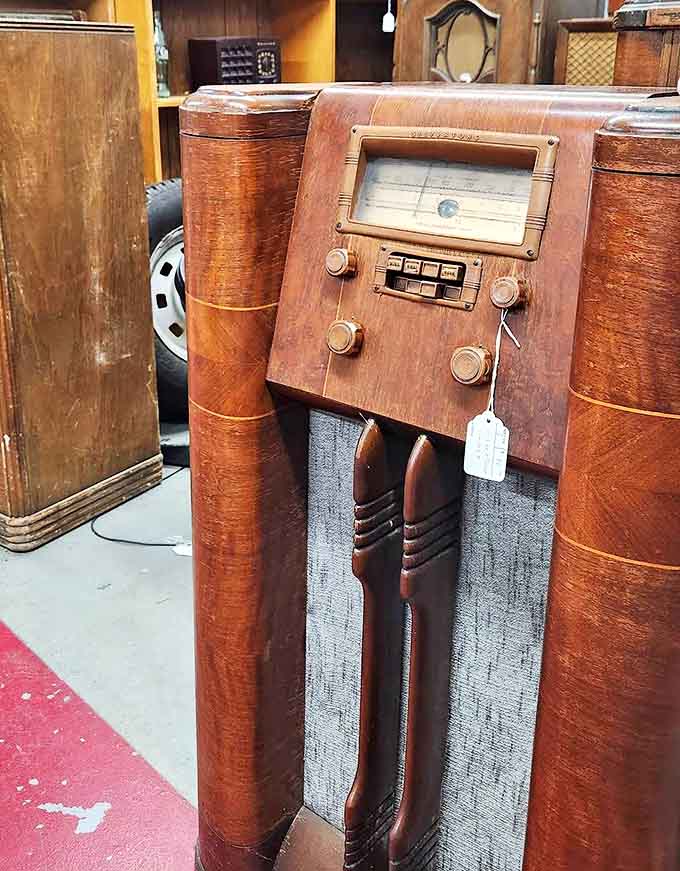 This magnificent wooden console radio once served as the heart of a family living room – entertainment furniture that doubled as art.