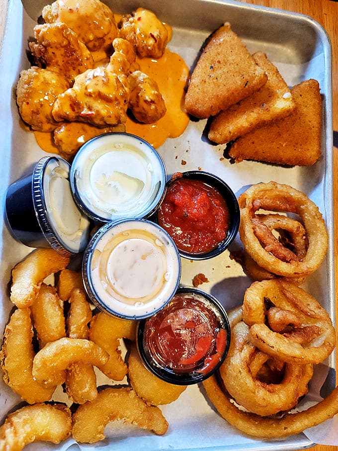 The appetizer sampler that's launched a thousand friendships &ndash; golden onion rings, crispy chicken bites, and dipping sauces worth fighting over.