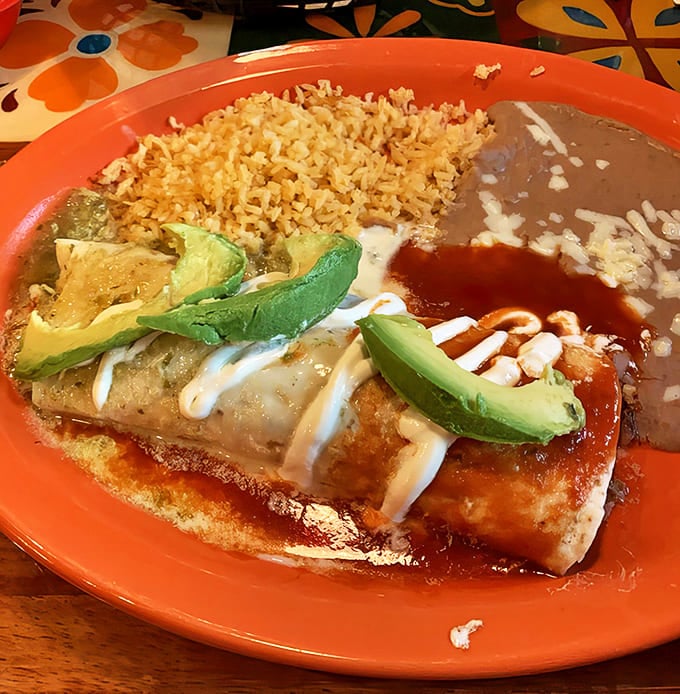 Azteca burrito: A masterclass in balance &ndash; crispy exterior giving way to tender filling, all dressed up with vibrant sauces and fresh avocado.
