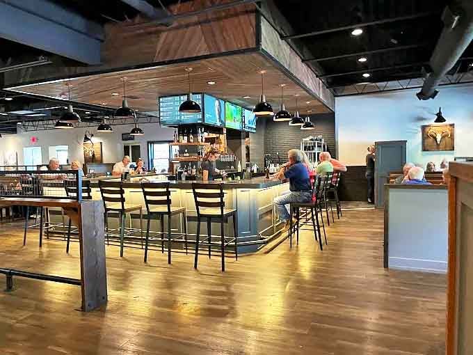 The bar gleams with promise, each bottle a potential companion to your meal, while warm lighting invites lingering conversations.