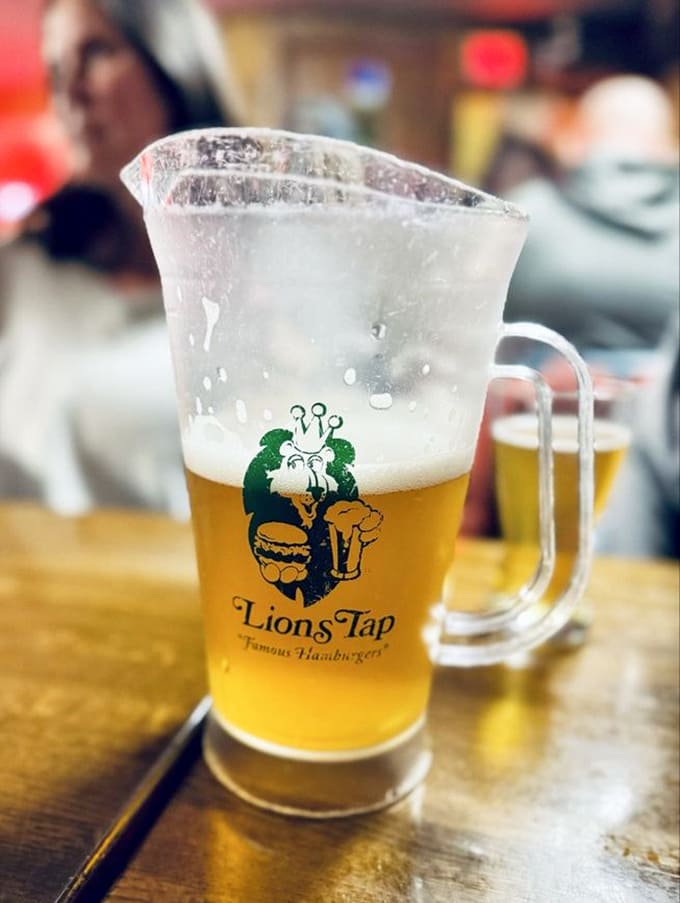 A cold pitcher of beer with that perfect golden glow, ready to complement your burger and make everything right with the world.