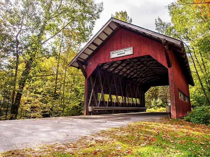 This rustic covered bridge isn't just Instagram bait&mdash;it's a portal to simpler times, framed by nature's most vibrant seasonal display.