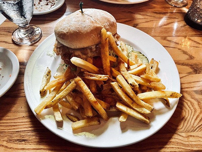 Holy cow, what a burger! This towering masterpiece of beef and bun is giving the Leaning Tower of Pisa a run for its money.