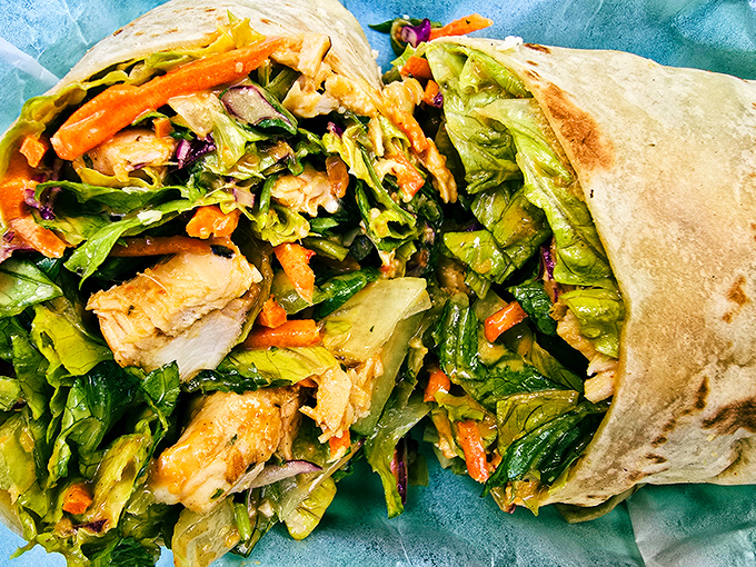 This burrito has achieved the impossible – containing a flavor explosion while maintaining structural integrity worthy of an engineering award.